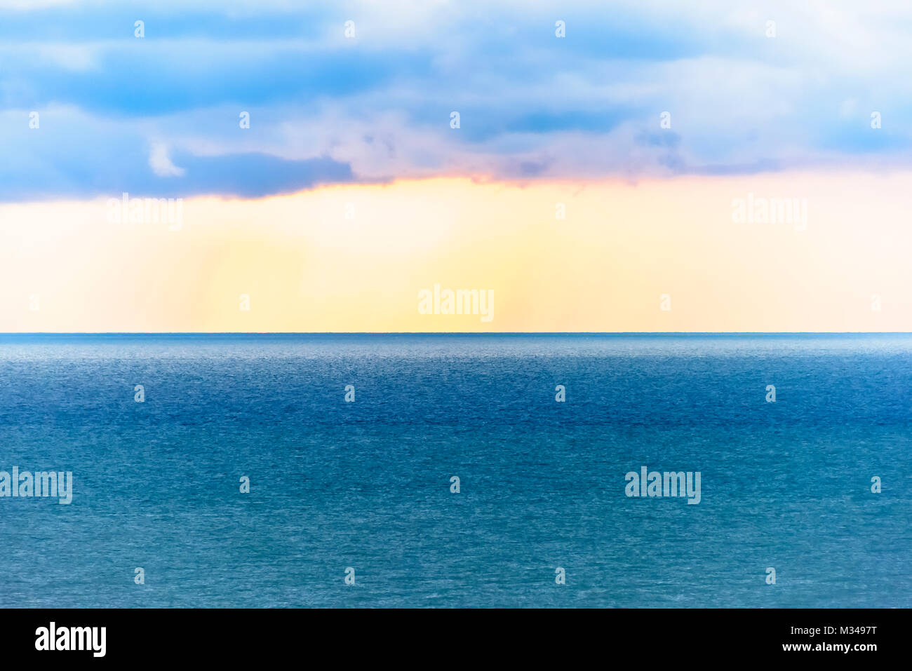 A calming, relaxing seascape oceanscape sunset showing a blue sea, blue ...