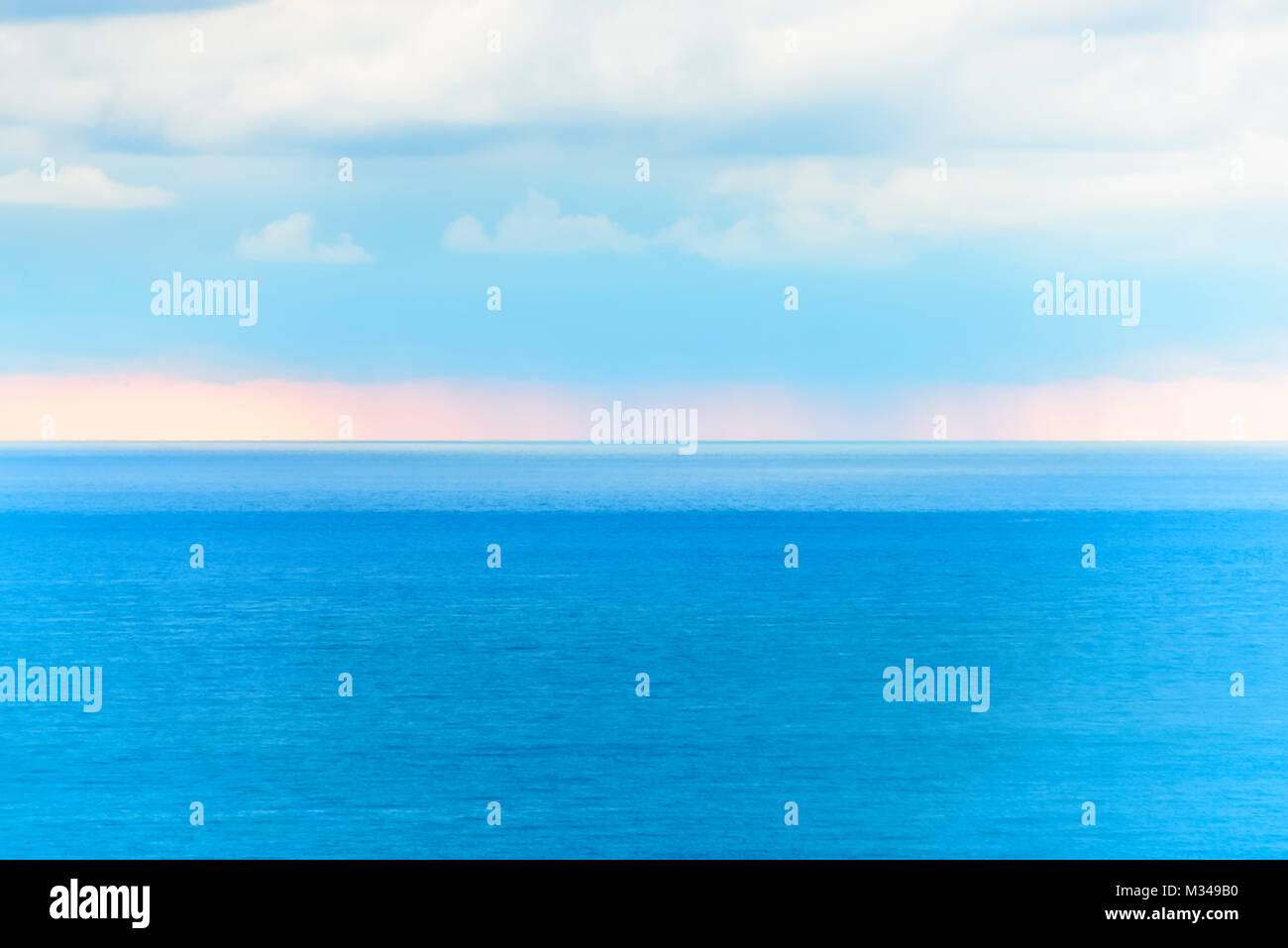 A calming, relaxing seascape oceanscape sunset showing a blue sea, blue ...