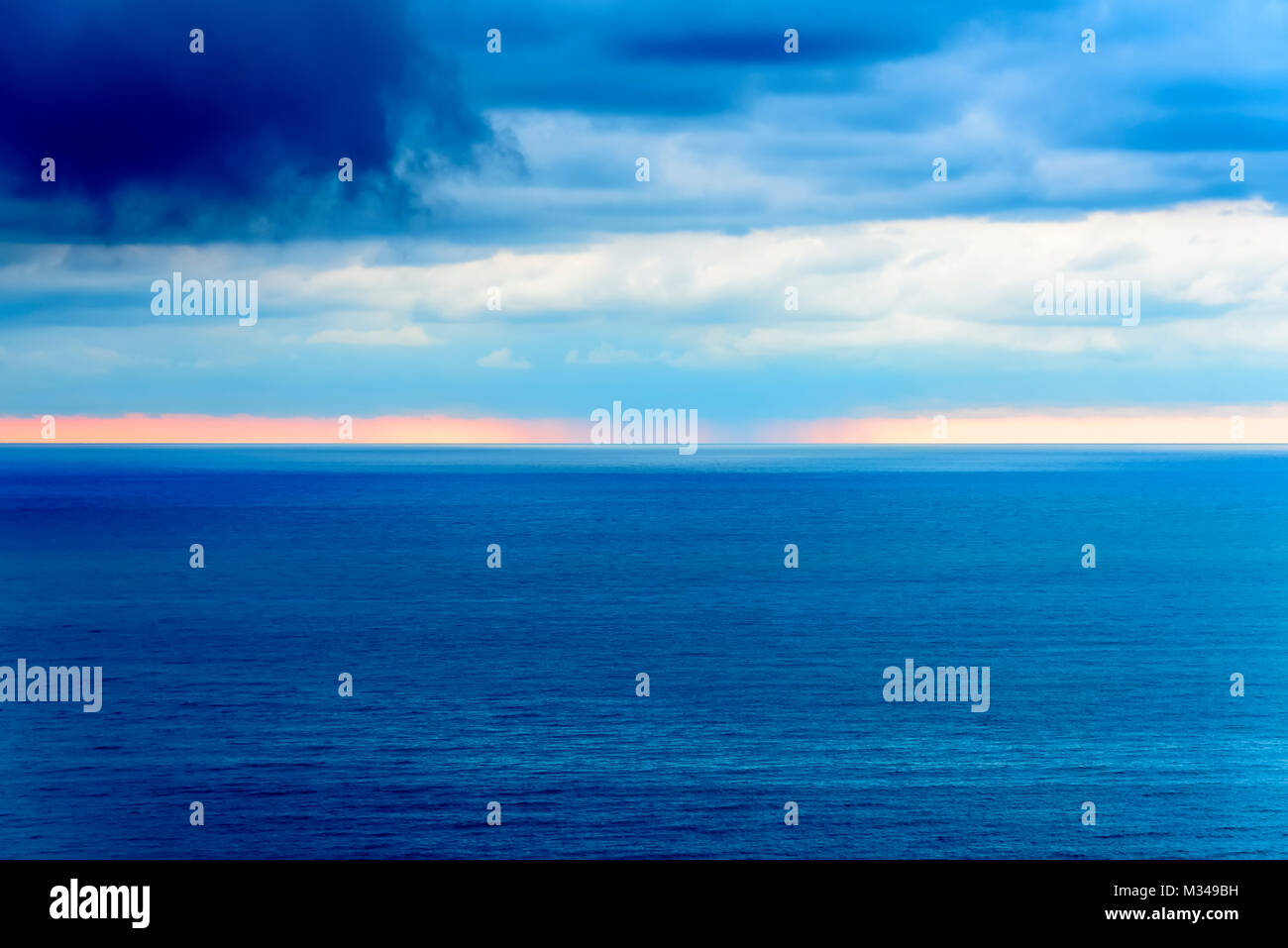A calming, relaxing seascape oceanscape sunset showing a blue sea, blue ...