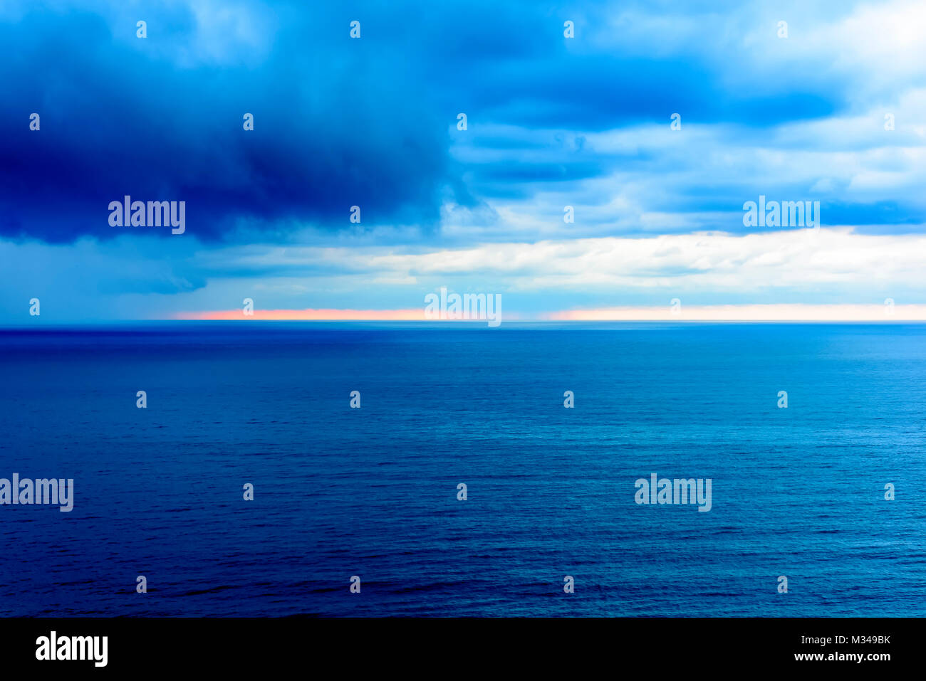 A calming, relaxing seascape oceanscape sunset showing a blue sea, blue ...