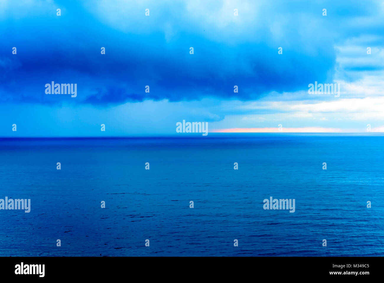 A calming, relaxing seascape oceanscape sunset showing a blue sea, blue ...