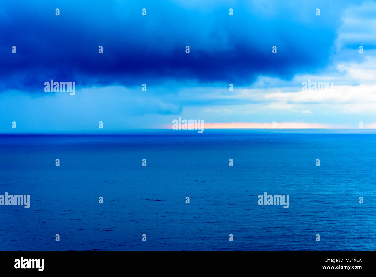 A calming, relaxing seascape oceanscape sunset showing a blue sea, blue ...