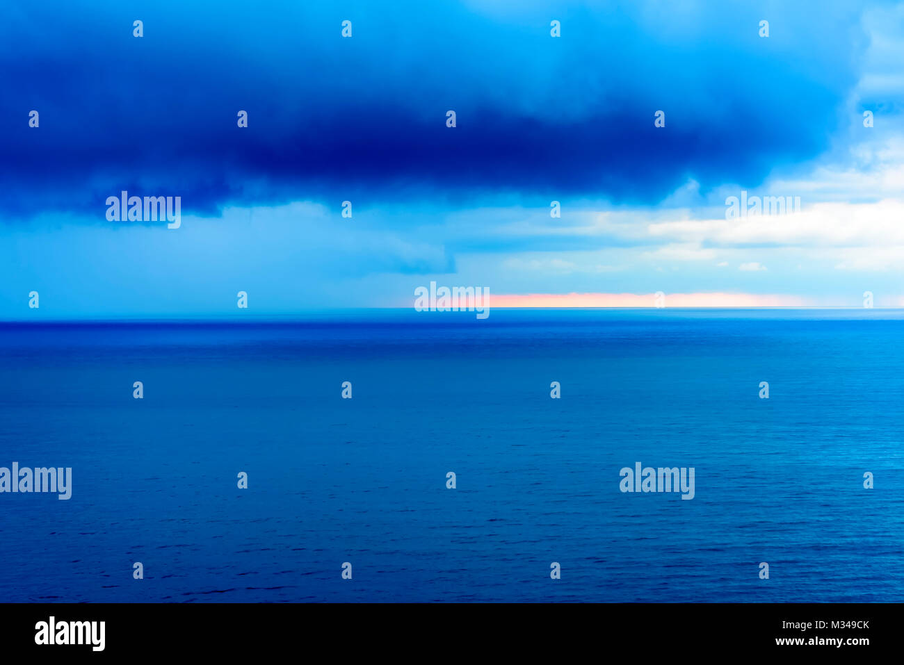 A calming, relaxing seascape oceanscape sunset showing a blue sea, blue ...