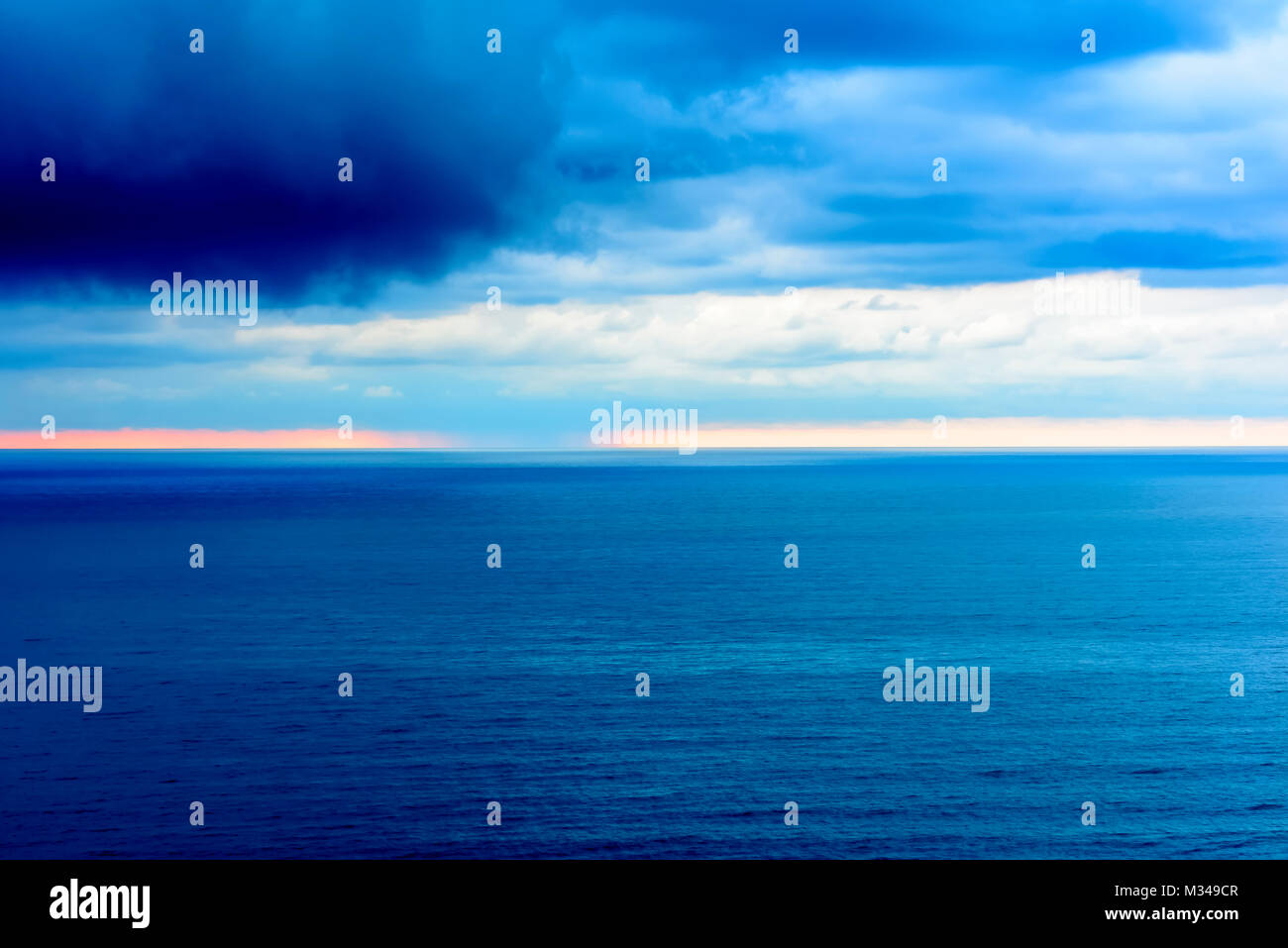A calming, relaxing seascape oceanscape sunset showing a blue sea, blue ...