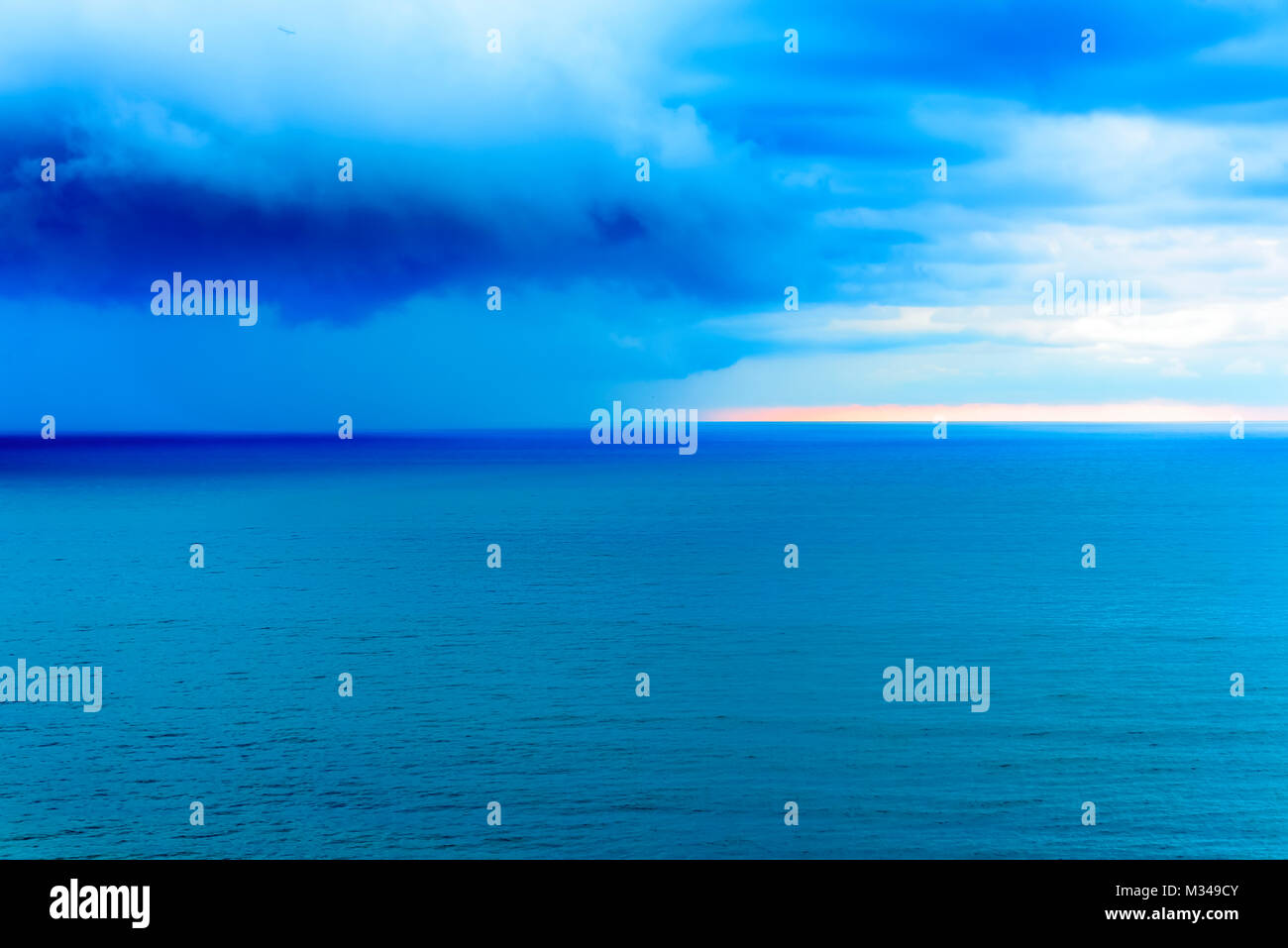 A calming, relaxing seascape oceanscape sunset showing a blue sea, blue ...