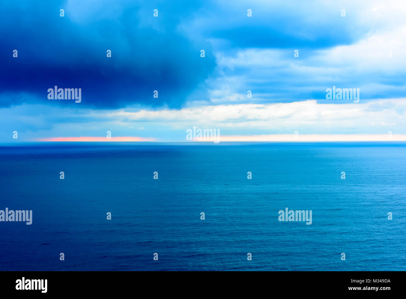 A calming, relaxing seascape oceanscape sunset showing a blue sea, blue ...