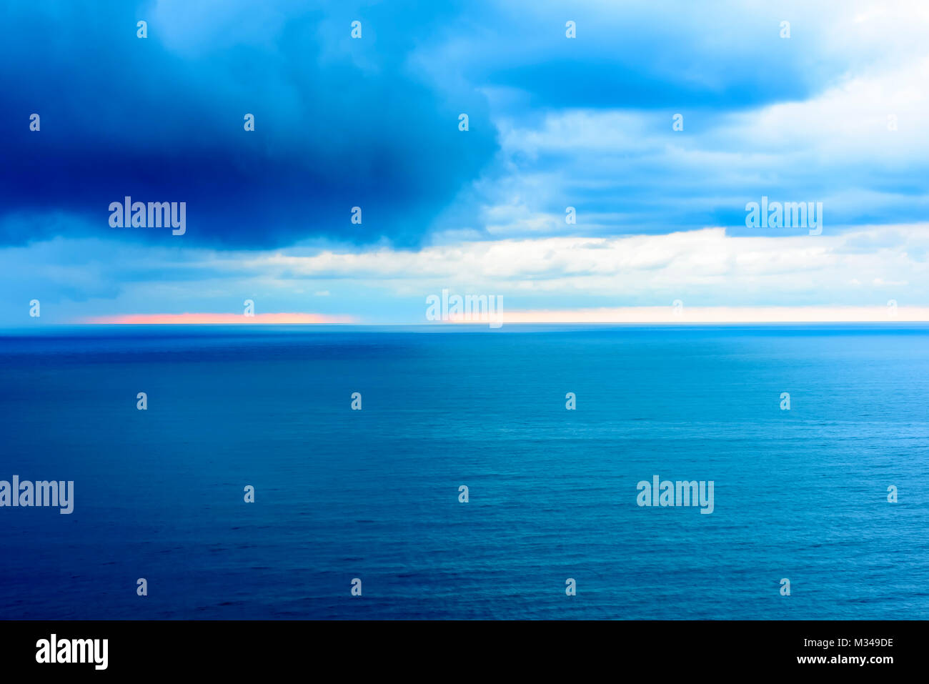 A calming, relaxing seascape oceanscape sunset showing a blue sea, blue ...