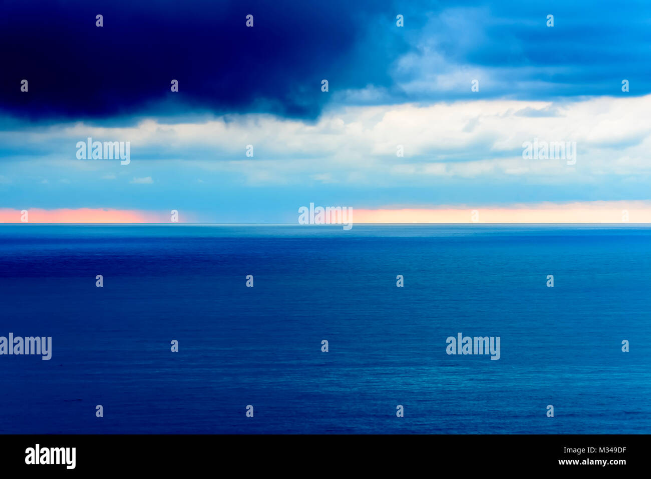 A calming, relaxing seascape oceanscape sunset showing a blue sea, blue ...