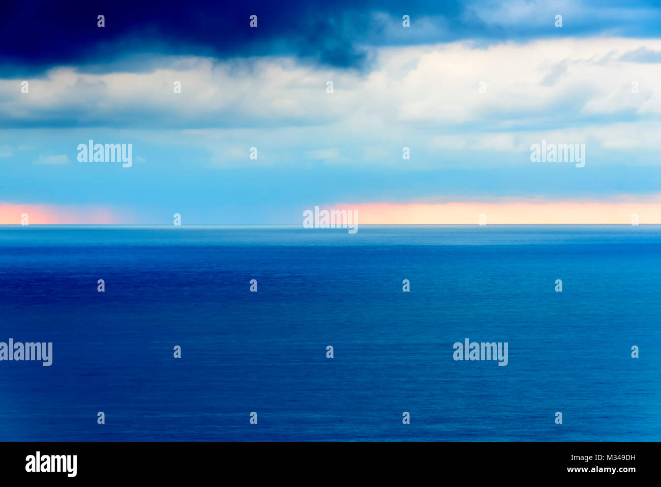 A calming, relaxing seascape oceanscape sunset showing a blue sea, blue ...