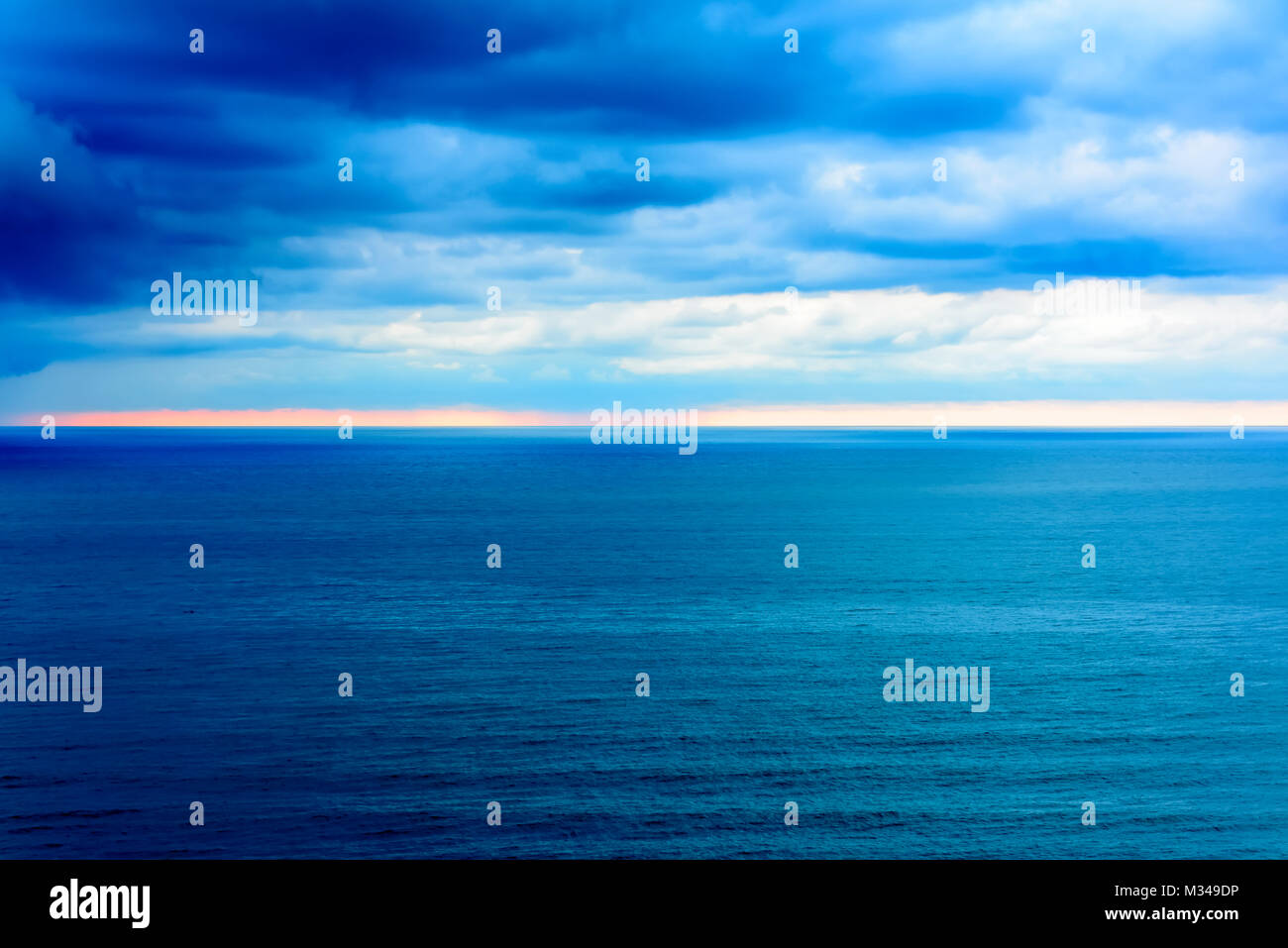 A calming, relaxing seascape oceanscape sunset showing a blue sea, blue ...