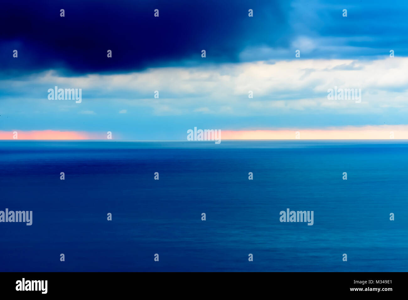 A calming, relaxing seascape oceanscape sunset showing a blue sea, blue ...