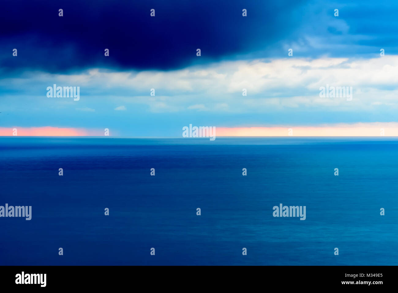 A calming, relaxing seascape oceanscape sunset showing a blue sea, blue ...