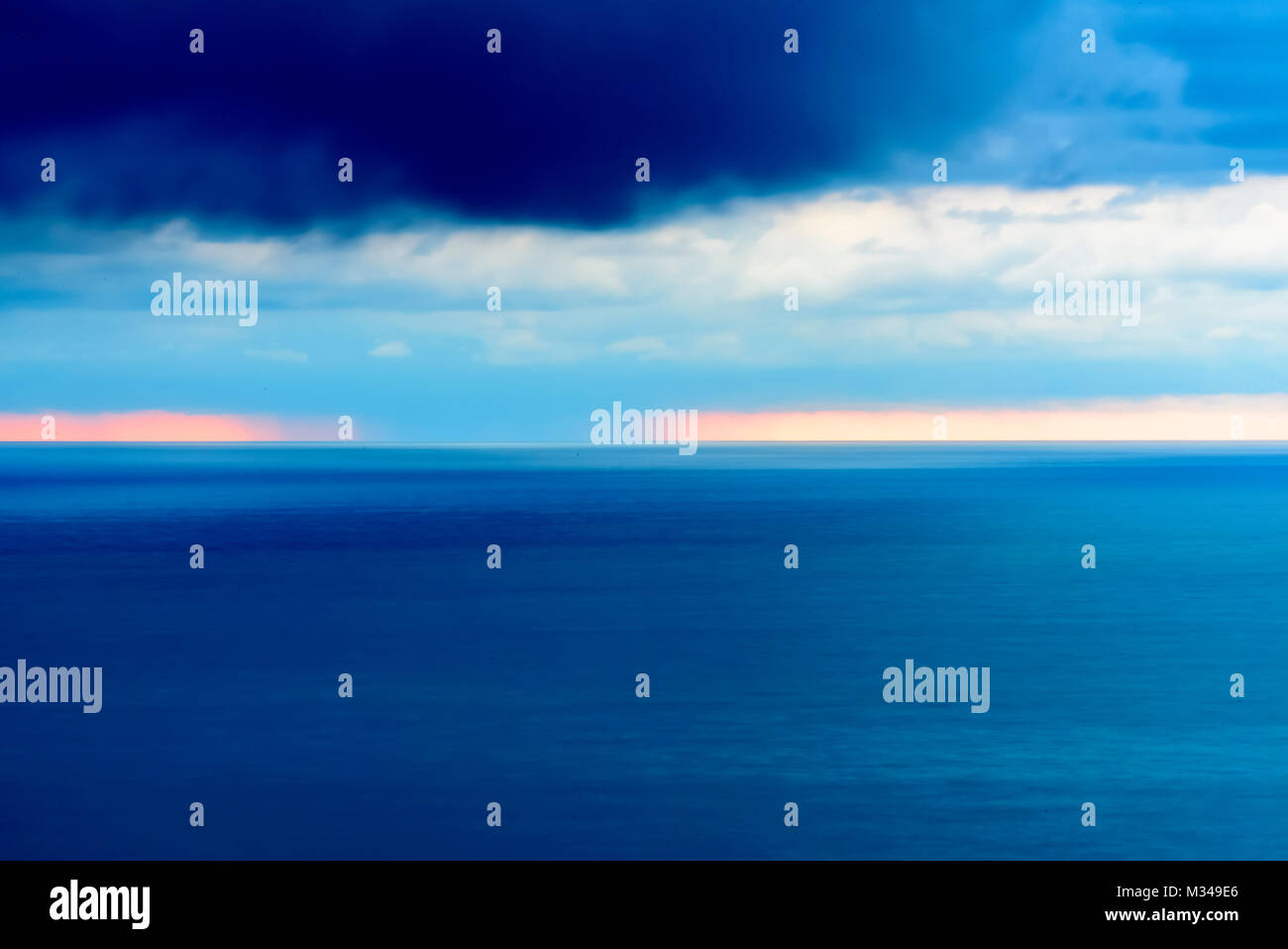 A calming, relaxing seascape oceanscape sunset showing a blue sea, blue ...