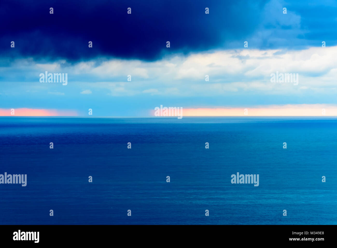 A calming, relaxing seascape oceanscape sunset showing a blue sea, blue ...