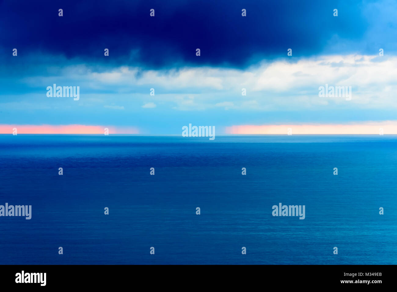 A calming, relaxing seascape oceanscape sunset showing a blue sea, blue ...