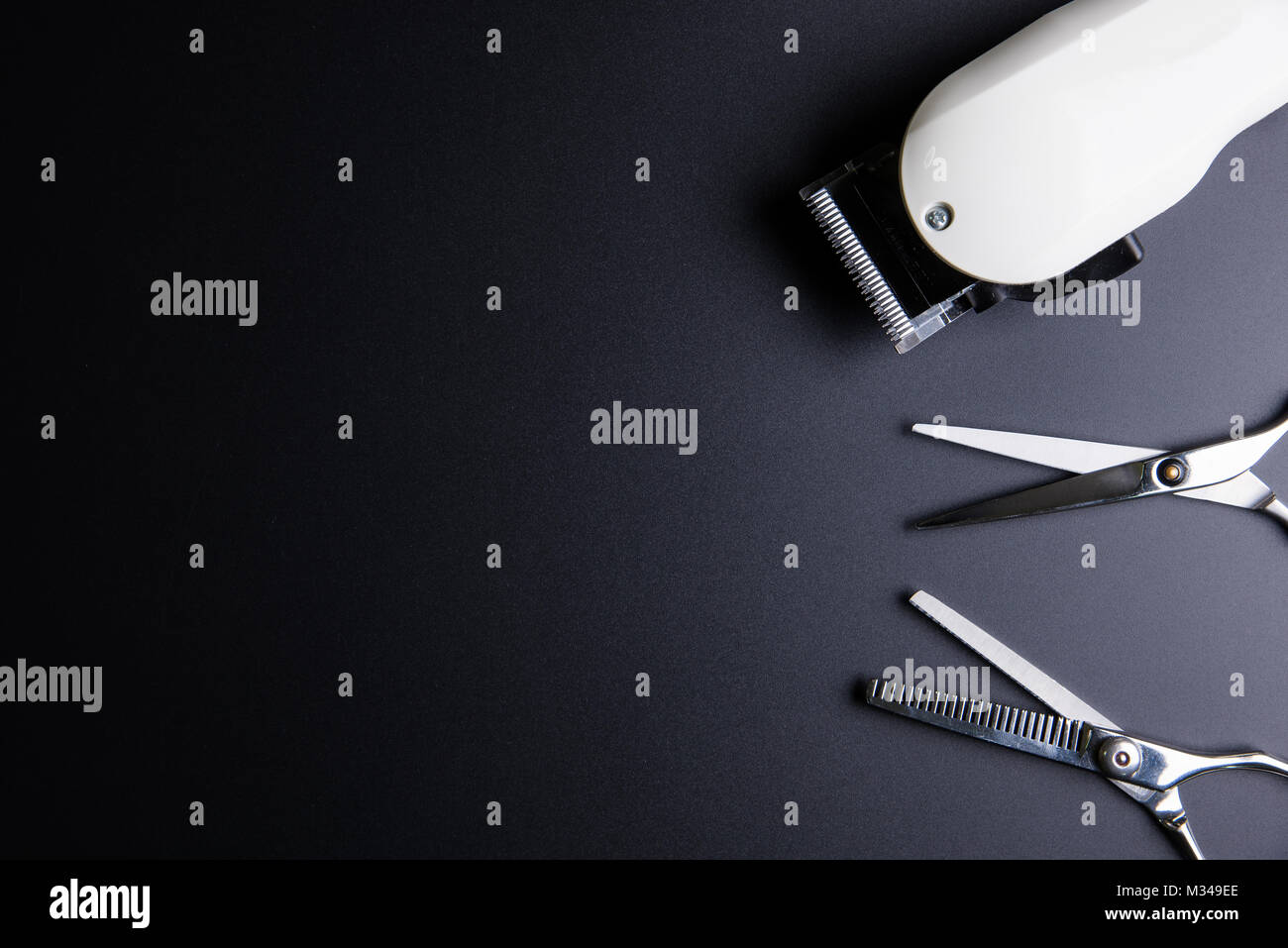 Stylish Professional Barber Scissors and White electric clippers on ...