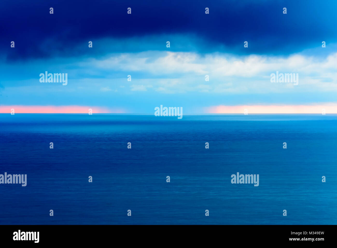 A calming, relaxing seascape oceanscape sunset showing a blue sea, blue ...