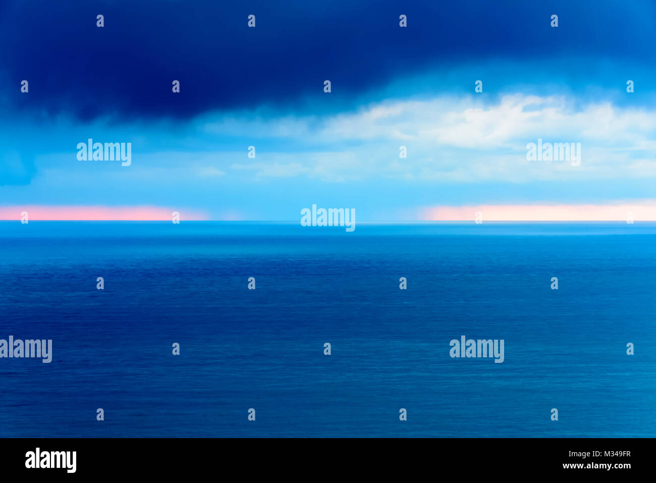 A calming, relaxing seascape oceanscape sunset showing a blue sea, blue ...