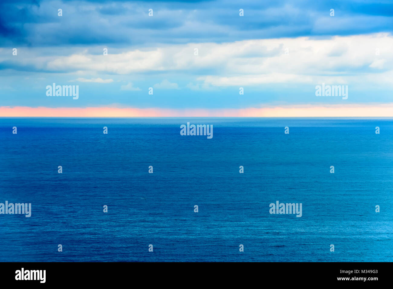 A calming, relaxing seascape oceanscape sunset showing a blue sea, blue ...