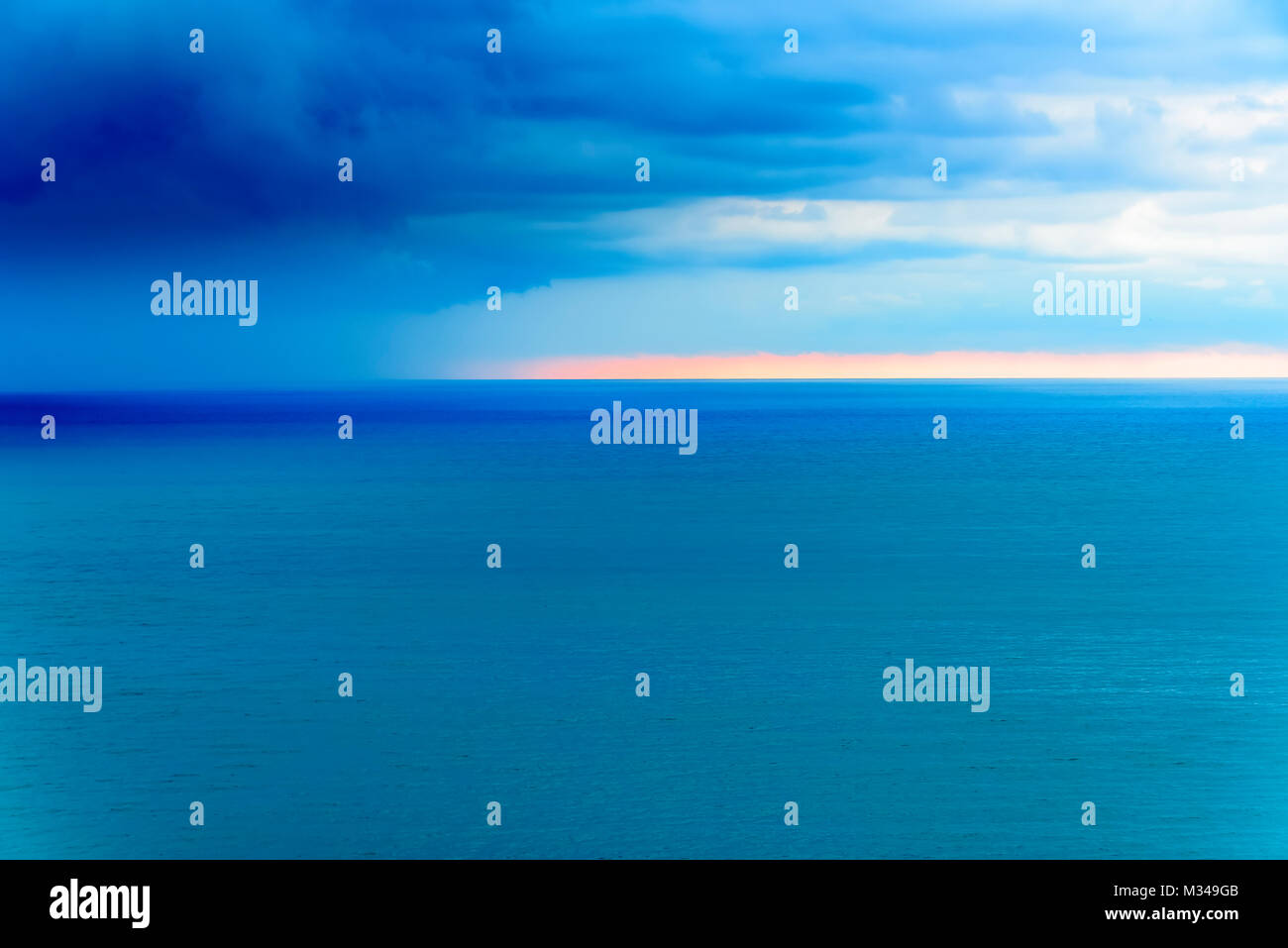 A calming, relaxing seascape oceanscape sunset showing a blue sea, blue ...