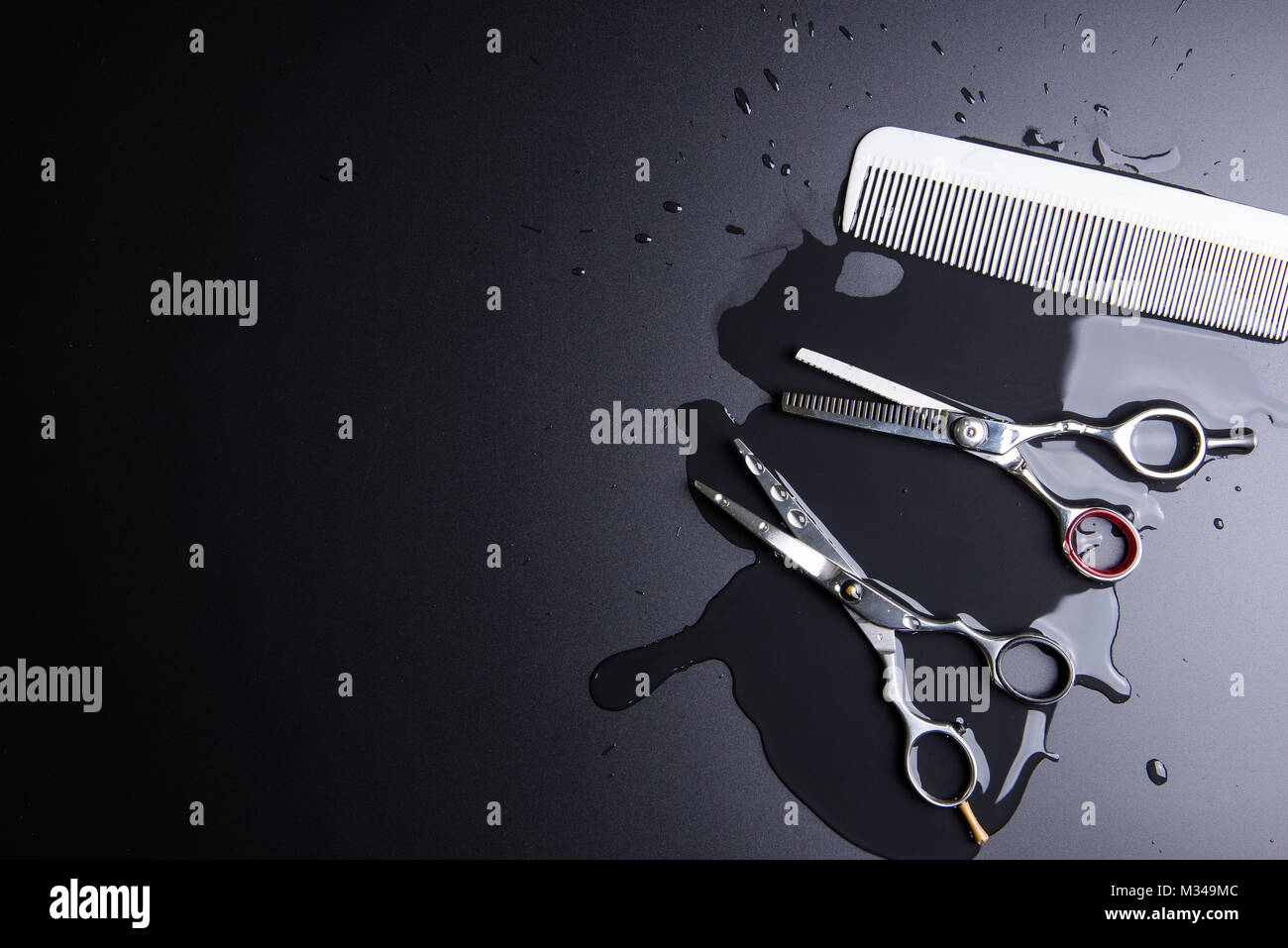 Stylish Professional Barber Scissors and white comb on black background ...