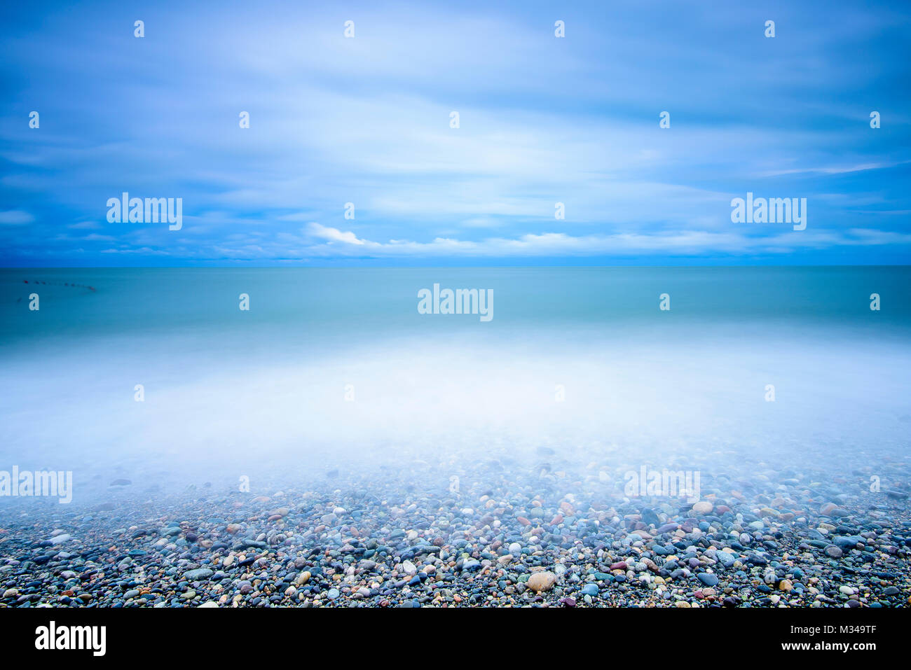 A calming, relaxing seascape oceanscape sunset showing a blue sea, blue ...