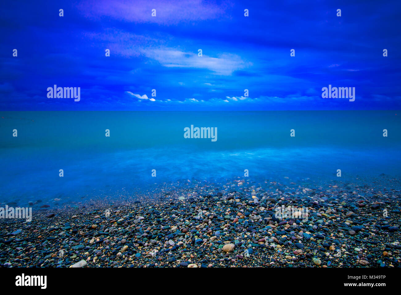 A calming, relaxing seascape oceanscape sunset showing a blue sea, blue ...