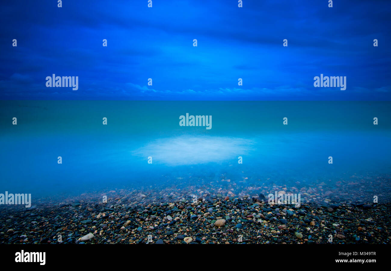 A calming, relaxing seascape oceanscape sunset showing a blue sea, blue ...