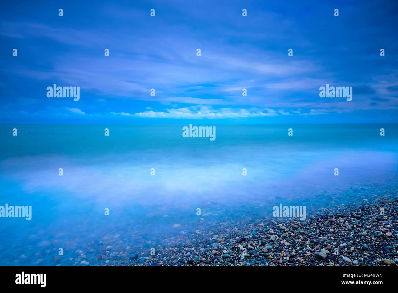 A calming, relaxing seascape oceanscape sunset showing a blue sea, blue ...