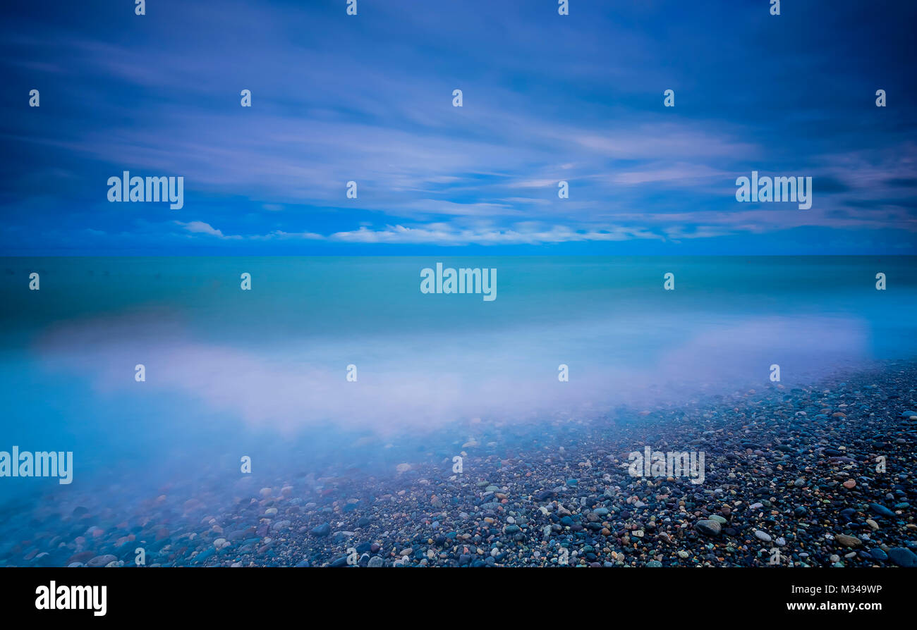 A calming, relaxing seascape oceanscape sunset showing a blue sea, blue ...