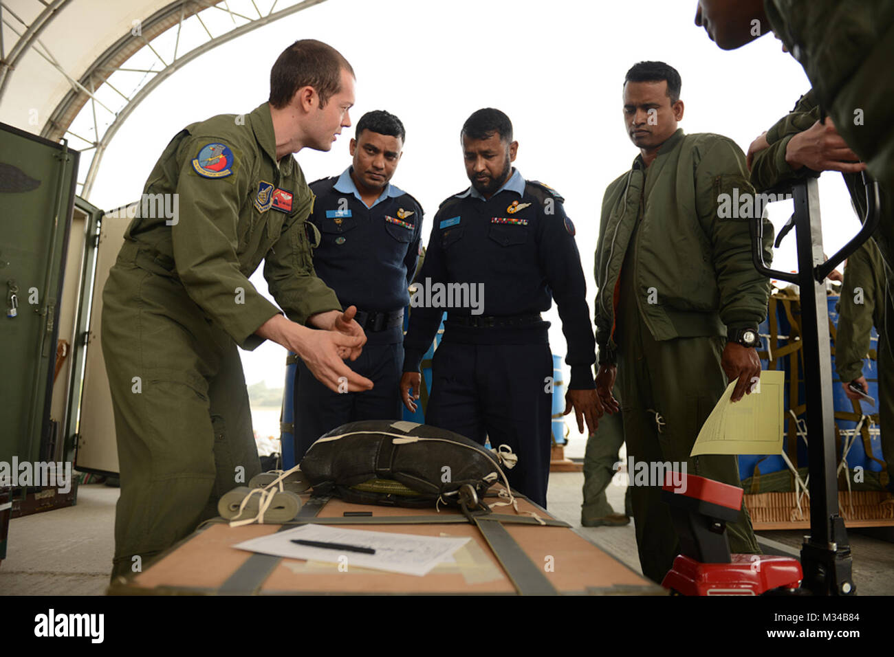 U.S. Air Force Tech. Sgt. Chris Nichols (left) speaks with Bangladesh ...