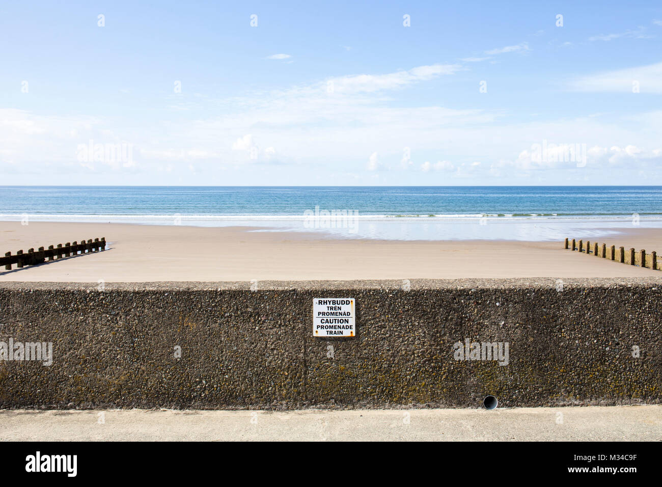 Caution promenade train warning sign in Barmouth Gwynedd North Wales UK ...