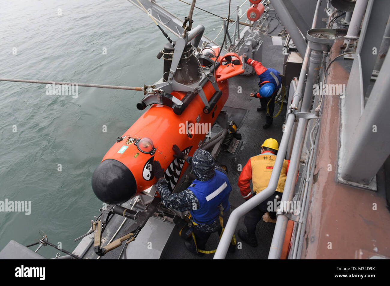 Sailors aboard the USS Chief operate a mine neutralization vehicle ...