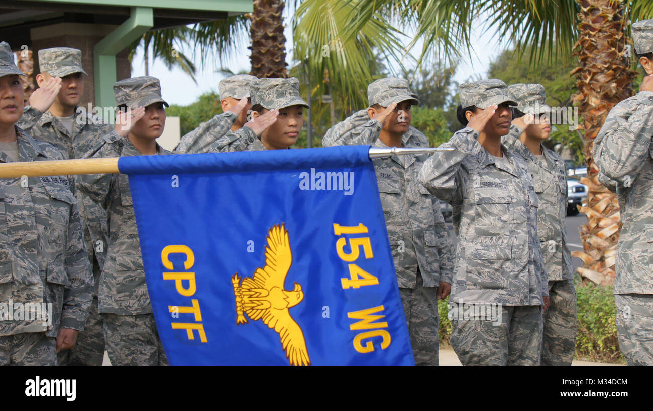 Members of the 154th Wing Comptroller Flight offer the opening salute ...