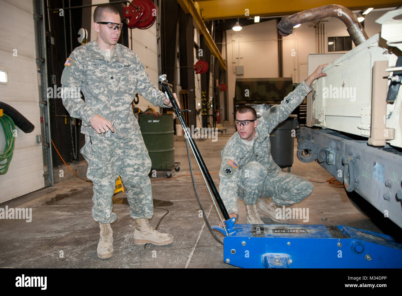 From left, military vehicle mechanics Spc. Joshua Harvey of Yukon ...