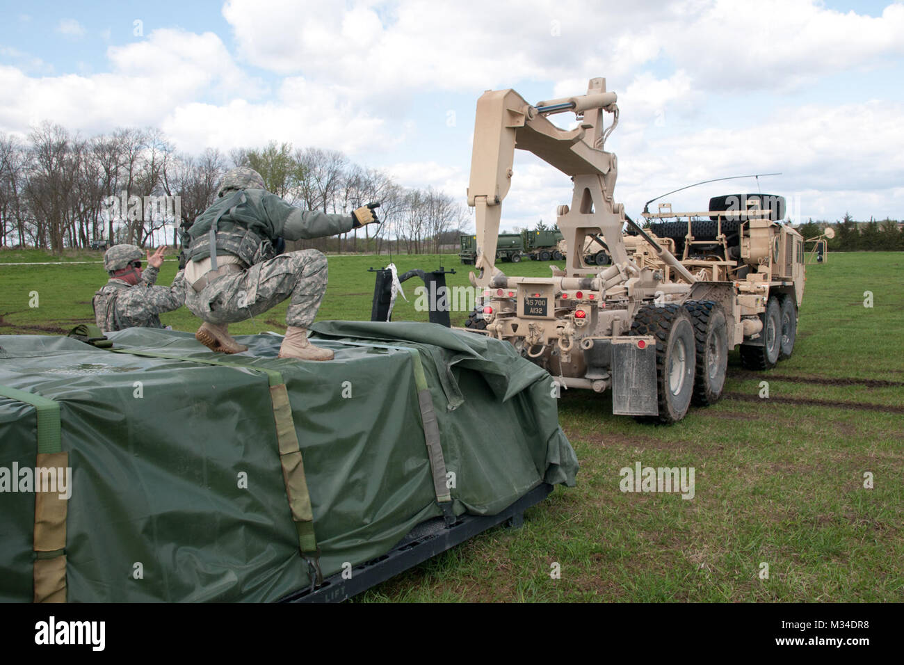 Soldiers from Company A, 700th Brigade Support Battalion, help attach ...