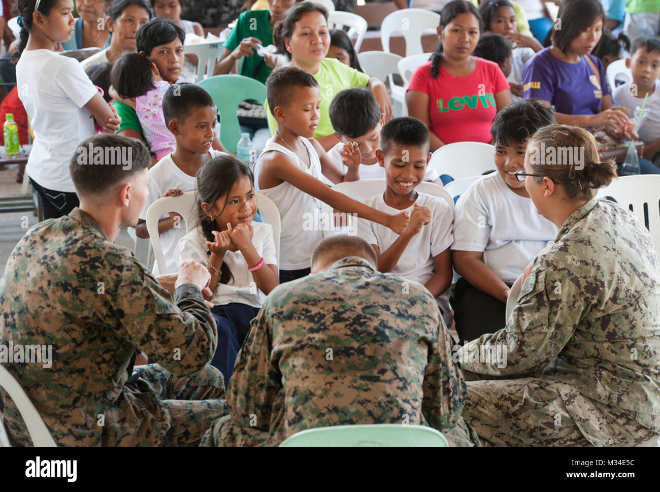 U.S. military service members talk to children during exercise ...