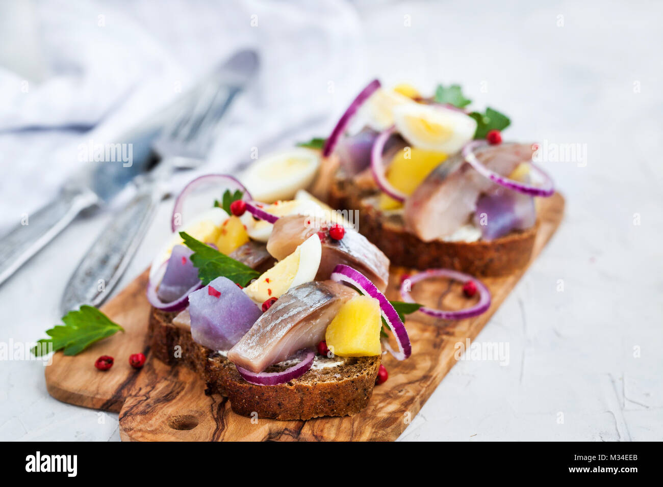 Open sandwich (smorrebrod) with herring, onion, potato and eggs Stock ...