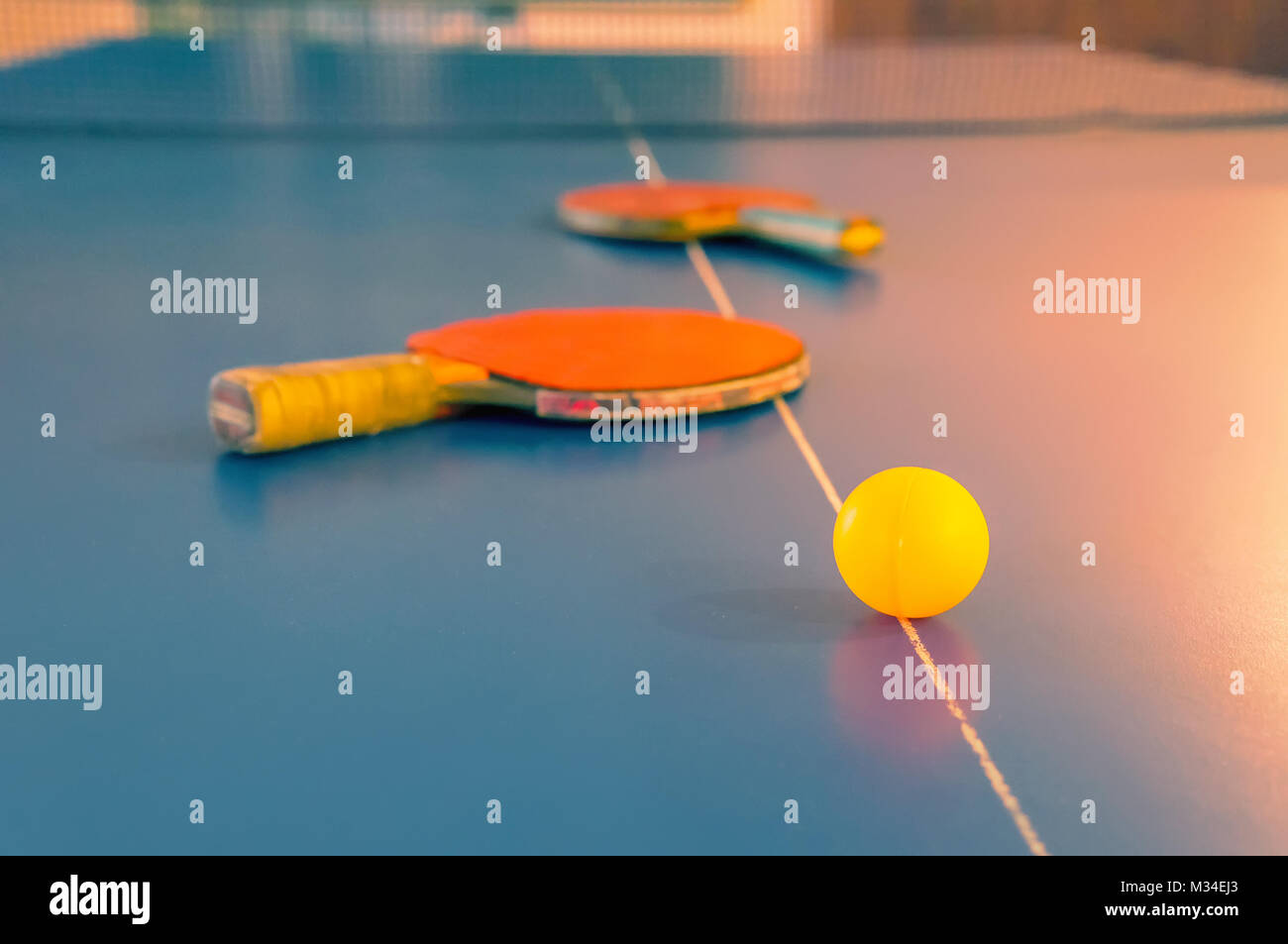 sports competitions in table tennis. two old orange tennis rackets and ...
