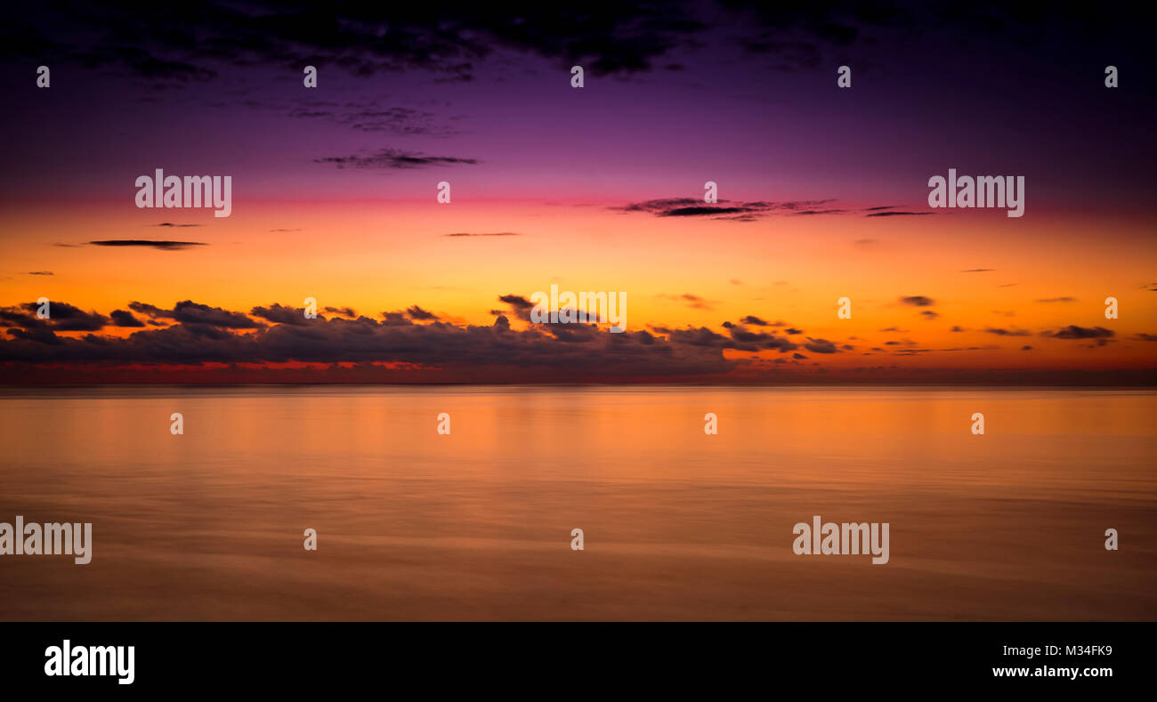 A calming, relaxing seascape oceanscape sunset showing a blue sea, blue ...