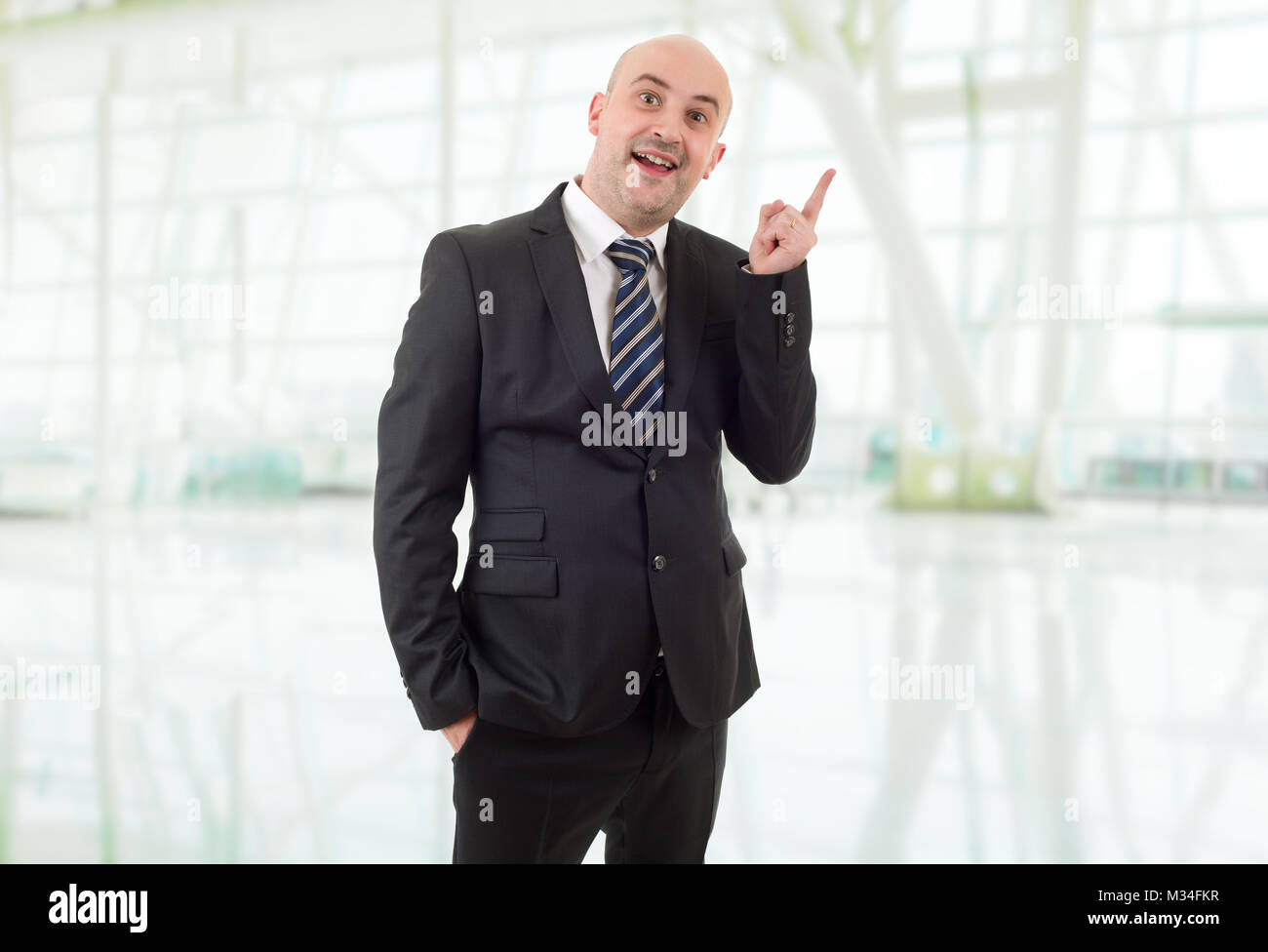 happy business man pointing, at the office Stock Photo - Alamy