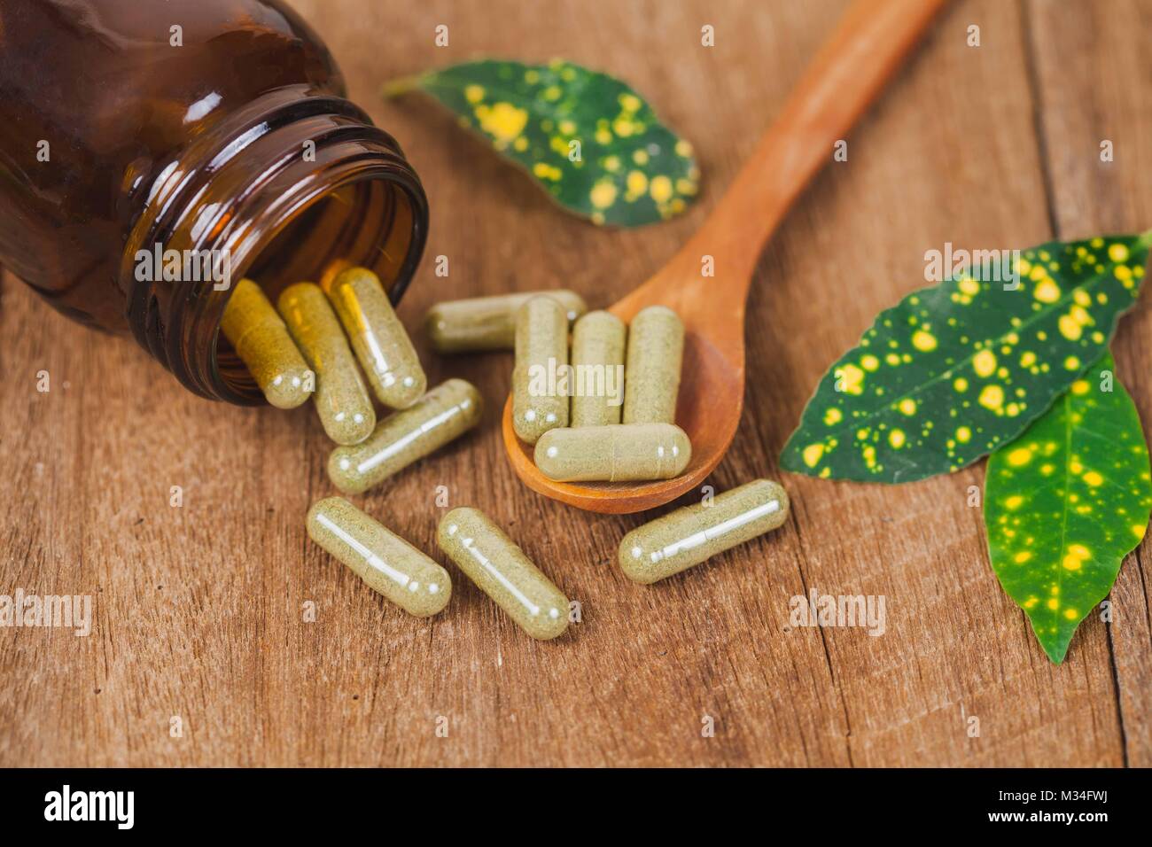 Herbal medicine capsules spilling out of a bottle ,soft focus Stock ...