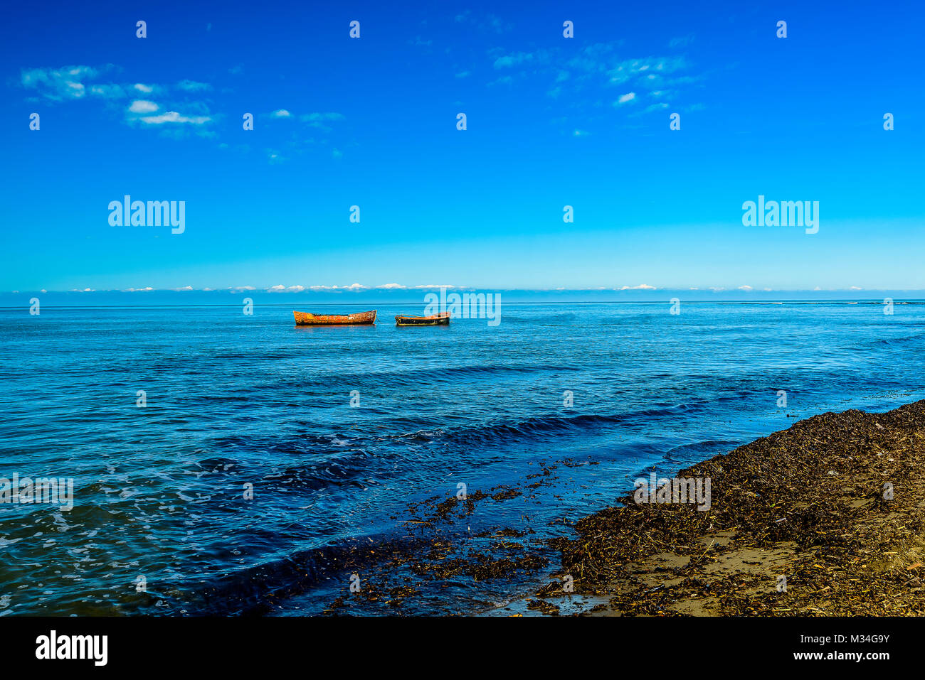 Wide angle landscape seascape showing fishing boats on a isolated beach ...