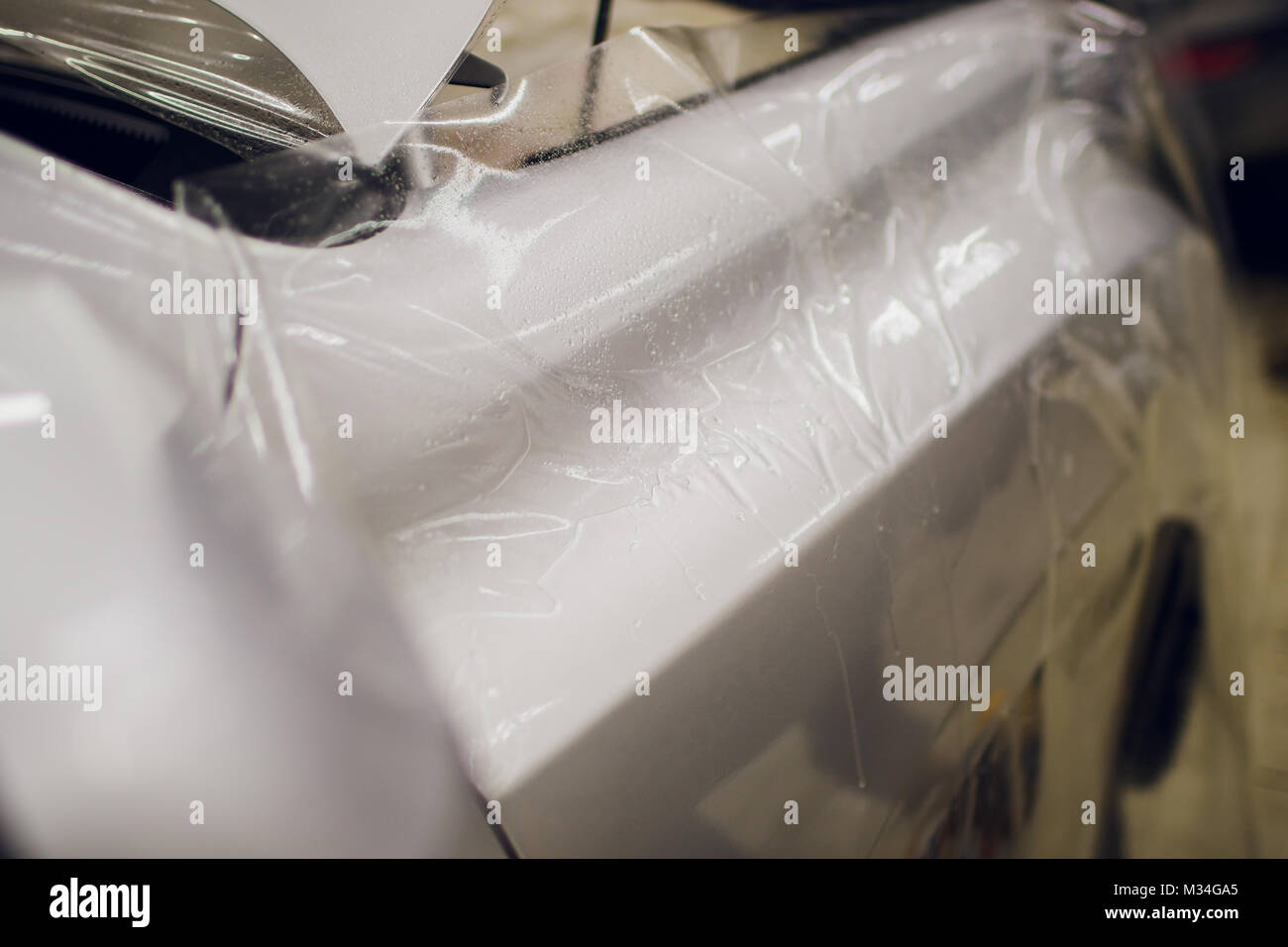 Car paint protection, protect coating installation man Stock Photo - Alamy