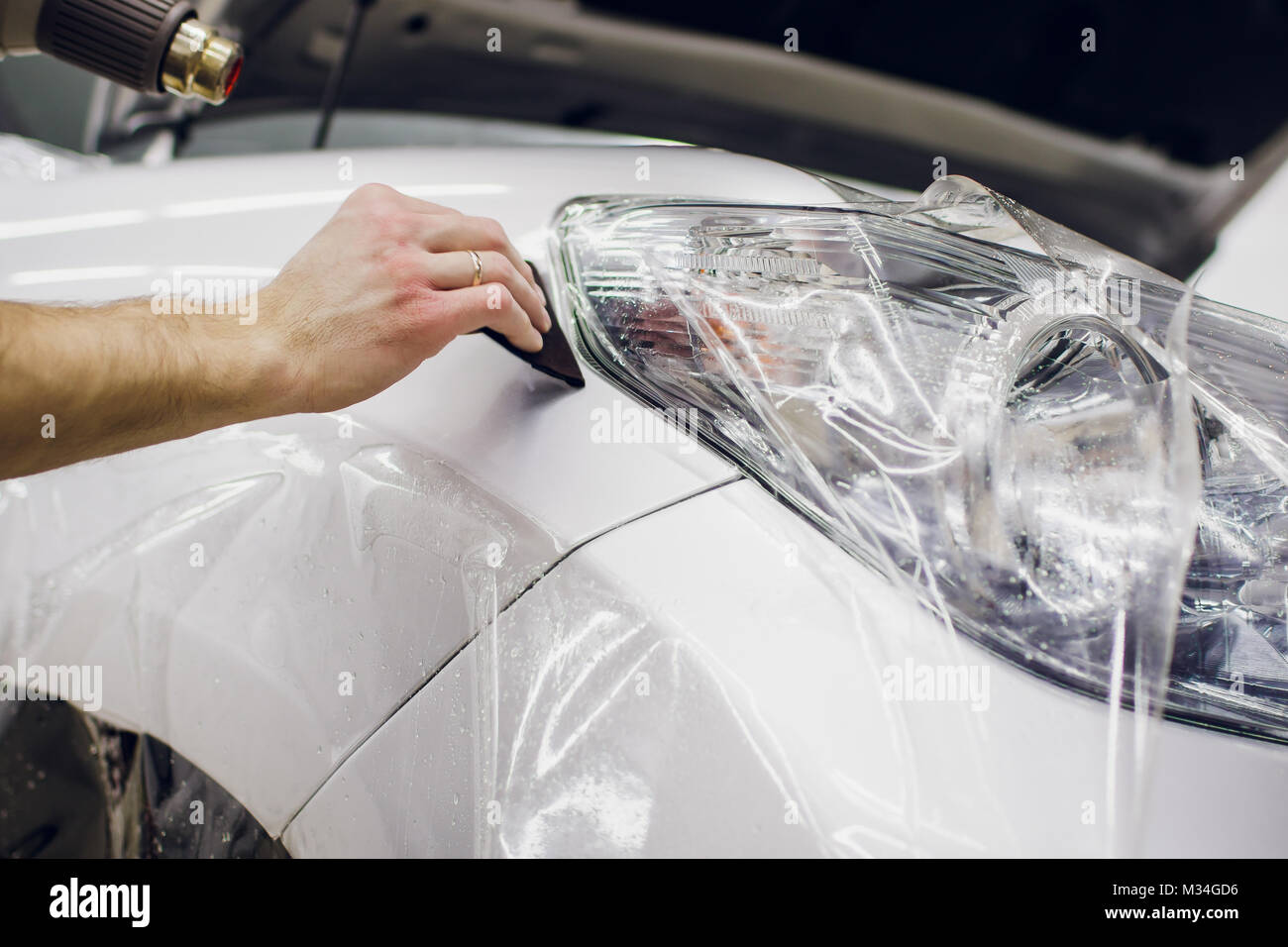 Car paint protection, protect coating installation man Stock Photo - Alamy