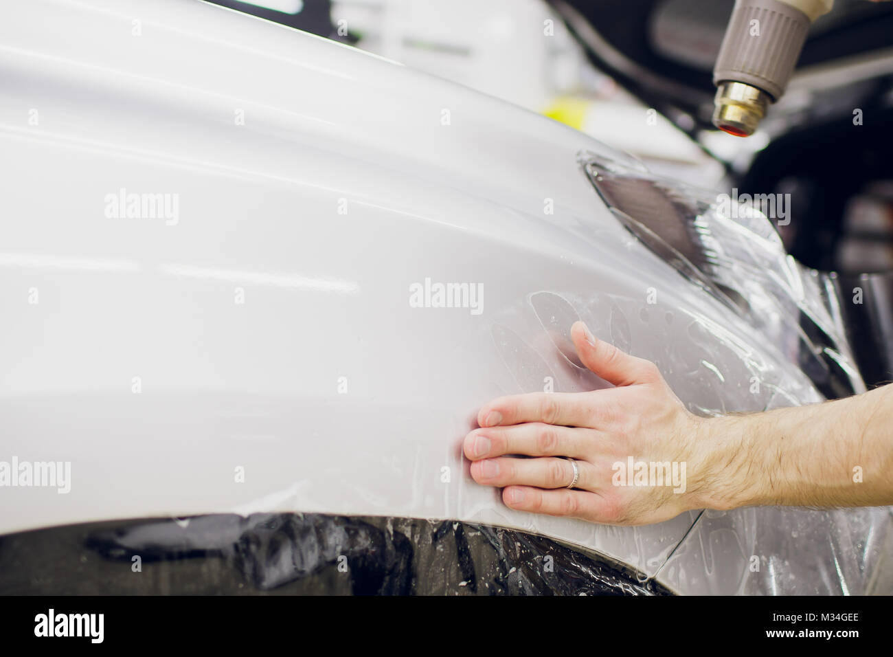 Car paint protection, protect coating installation man Stock Photo - Alamy