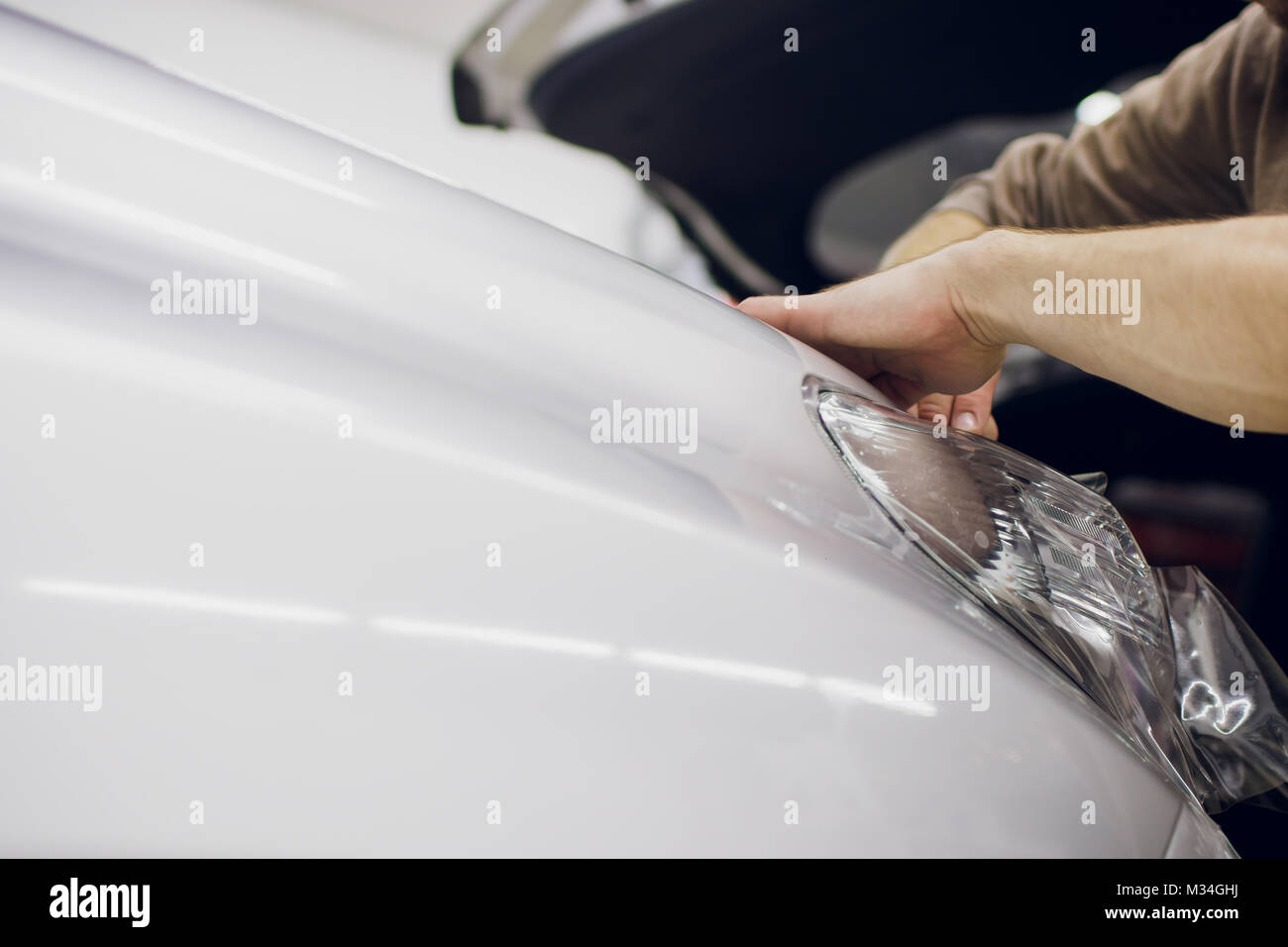 Car paint protection, protect coating installation man Stock Photo - Alamy