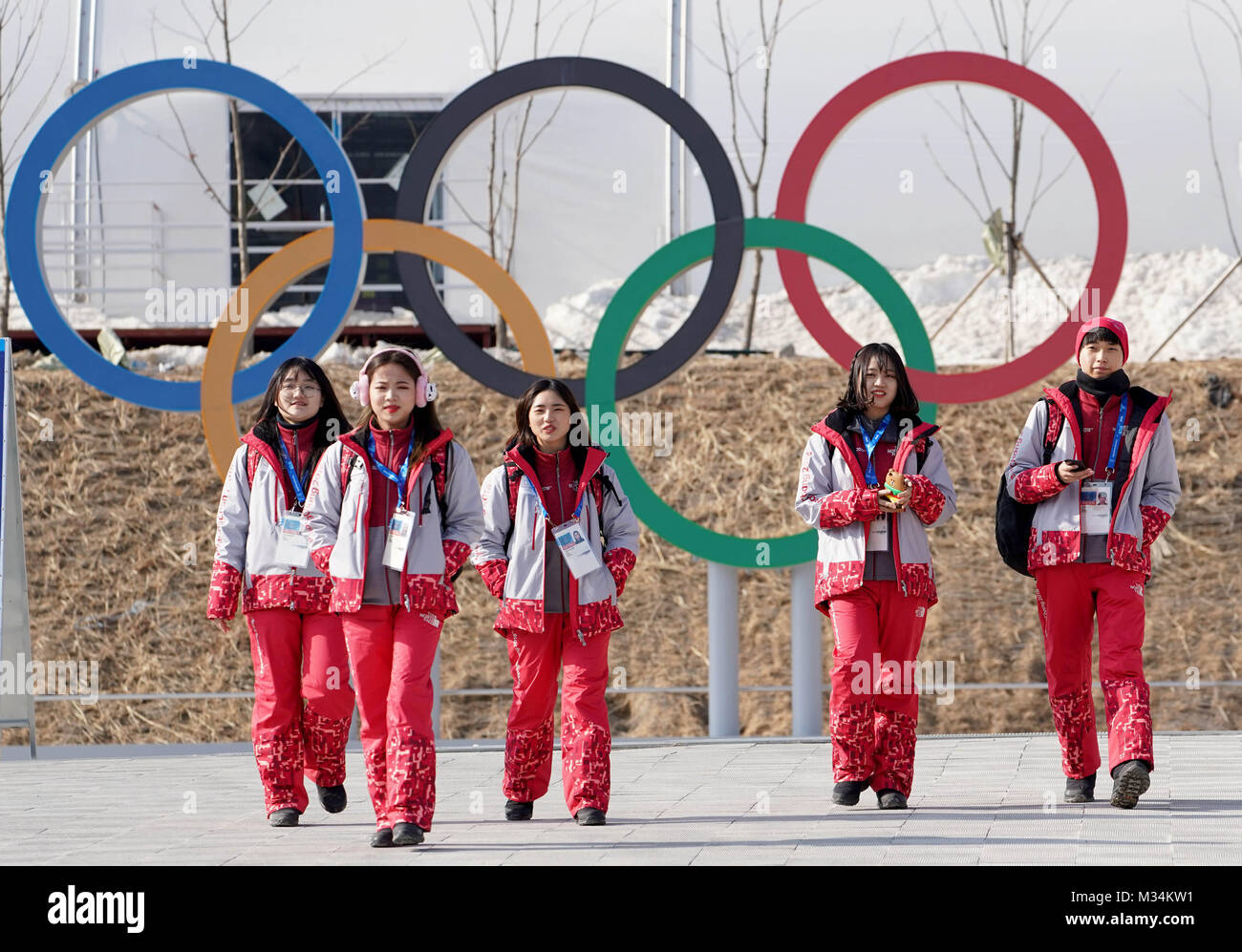 Pyeongchang, South Korea. 9th Feb, 2018. Volunteers walk past the ...