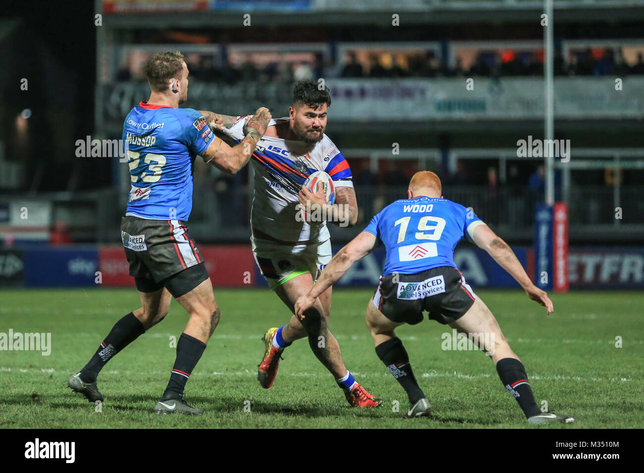 David Fifita of Wakefield Trinity is tackled by Lee Mossop of Salford ...