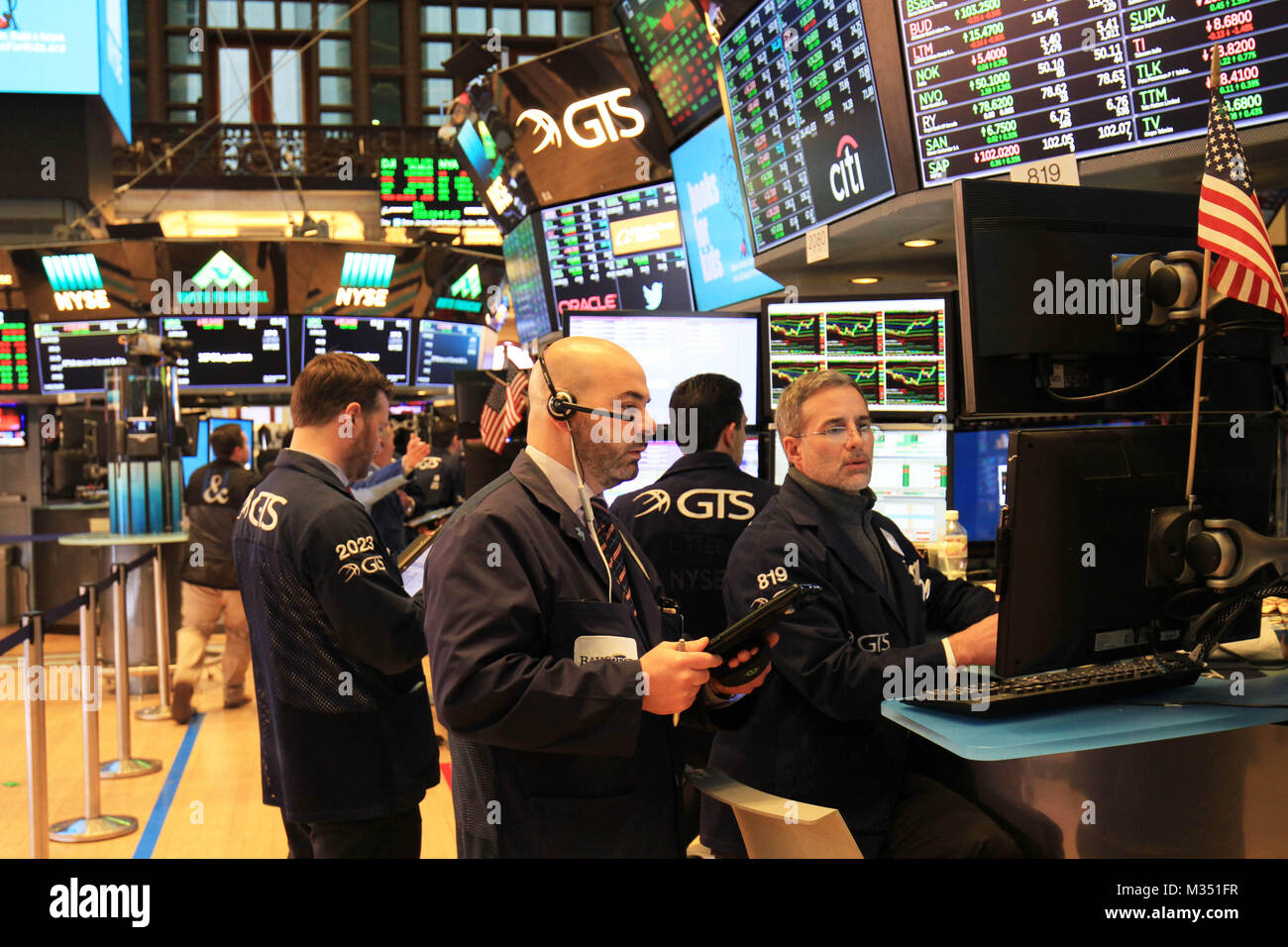 New York, USA. 9th Feb, 2018. Traders work at the trading floor of the ...